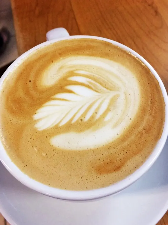 Latte art so pretty, you almost don't want to drink it… almost. This leafy design is like a caffeinated Rorschach test for coffee lovers.