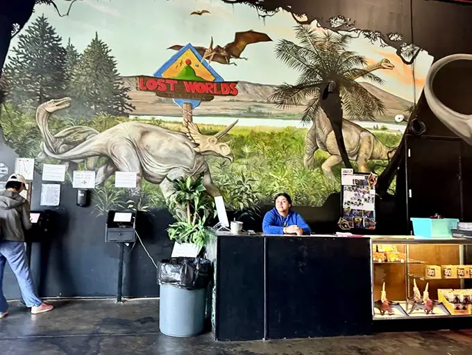 "Clever girl." This welcoming desk is your gateway to adventure, staffed by friendly faces ready to guide you through 65 million years of fun.