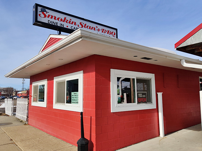 Welcome to BBQ paradise! Smokin Stan's charming exterior promises a feast for the senses, with its inviting porch and vibrant flowers setting the stage for smoky delights within.
