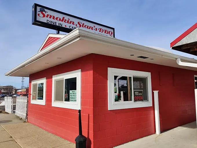Welcome to BBQ paradise! Smokin Stan's charming exterior promises a feast for the senses, with its inviting porch and vibrant flowers setting the stage for smoky delights within.