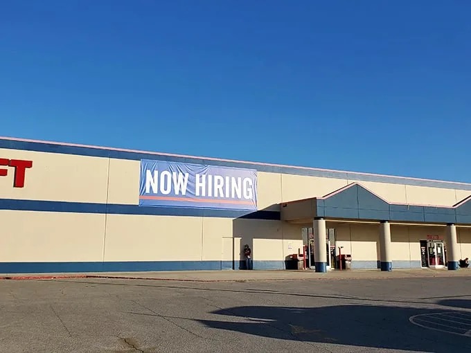 "Now Hiring" - a sign of the times or an invitation to join the treasure hunt? This thrift store's exterior promises adventures in bargain-hunting.