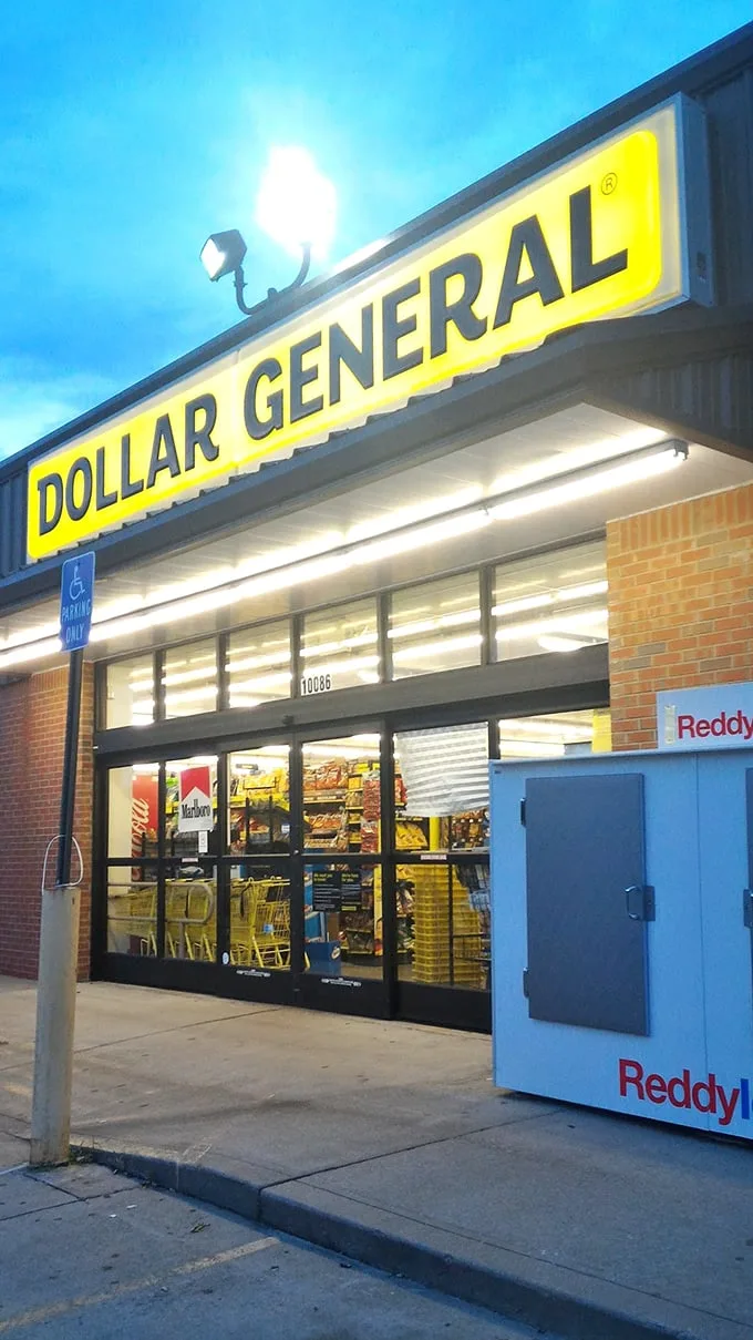 The iconic yellow sign against a clear Tennessee sky—Dollar General's brick-and-mortar promise of bargains beckons shoppers like a budget-friendly lighthouse.