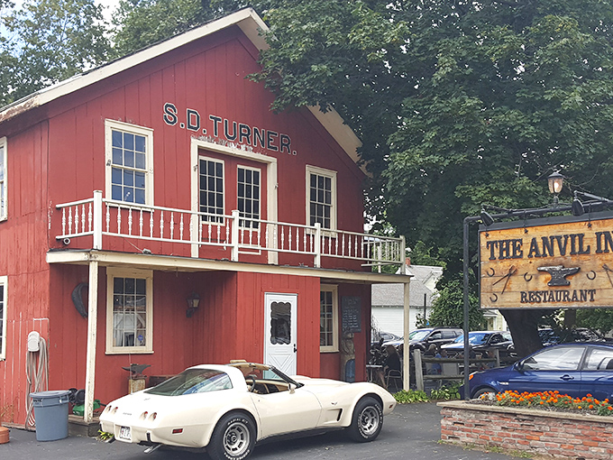 A red barn that's not for cows, but for carnivores! The Anvil Inn's exterior promises a cozy retreat for steak lovers.