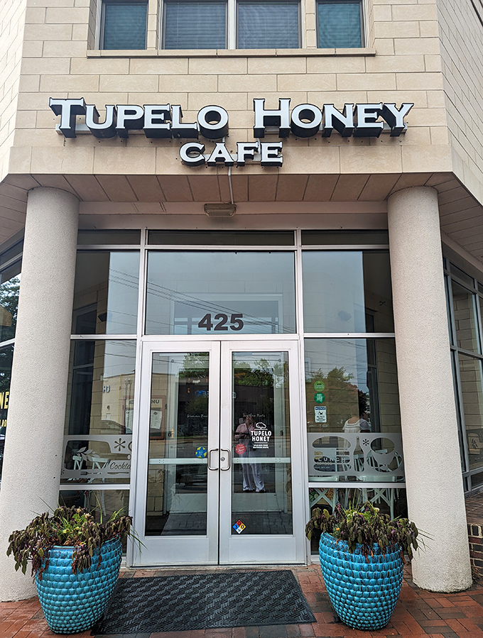 The warm, inviting façade of Tupelo Honey beckons with blue planters standing guard like Southern sentinels ready to welcome hungry visitors. 