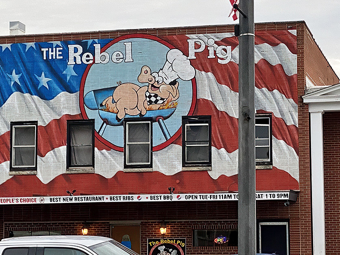 The patriotic pig has landed! This eye-catching mural promises smoky delights within—like a meaty Statue of Liberty beckoning the hungry masses.