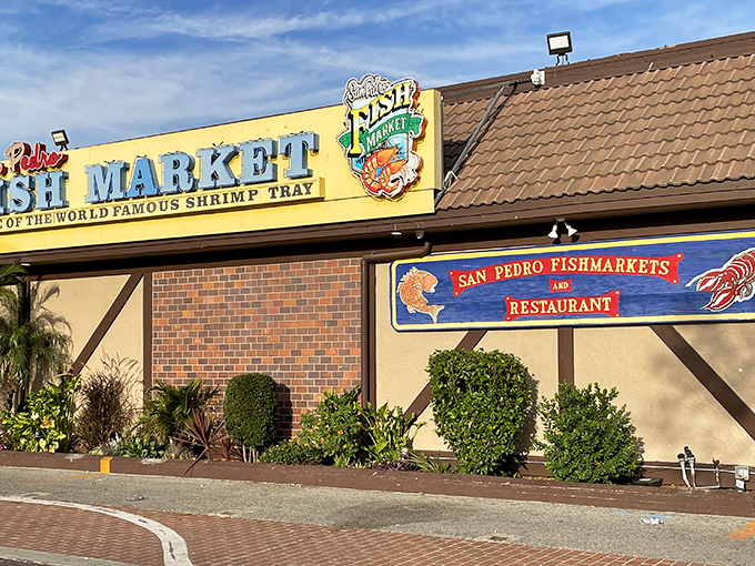 Welcome to seafood paradise! San Pedro Fish Market's vibrant exterior promises a feast for the senses, with its cheerful yellow walls and colorful signage beckoning hungry visitors.