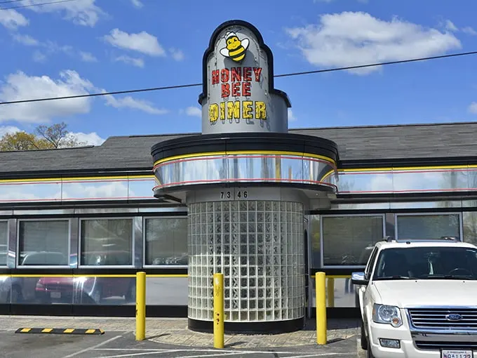 Welcome to the Honey Bee Diner, where retro charm meets modern appetite! This gleaming silver facade is like a beacon for comfort food lovers.