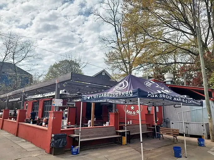 The bright red exterior of Fox Bros. Bar-B-Q stands like a barbecue beacon, promising smoky treasures within. No wonder license plates from across the South fill the parking lot.