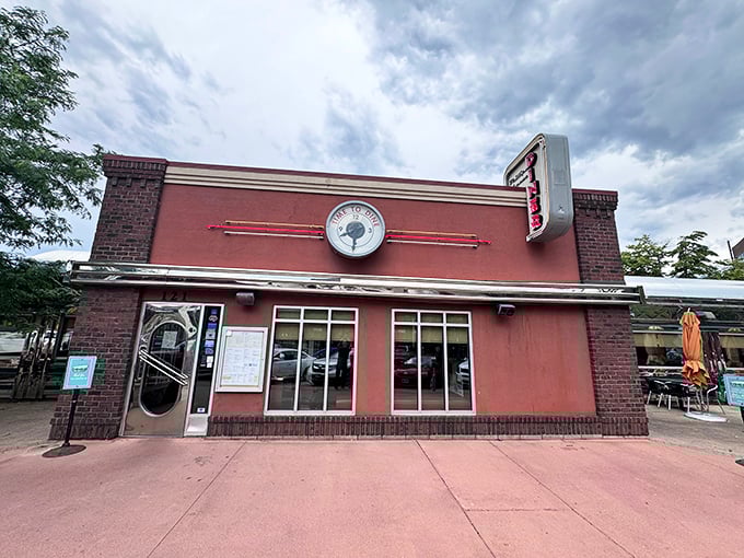 Step back in time! This salmon-pink facade isn't just a building, it's a portal to the golden age of chrome and vinyl.