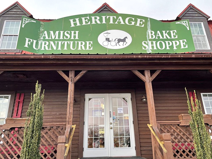 The red metal roof and welcoming wooden porch of Heritage Bake Shoppe stand as a rustic oasis amid Virginia Beach's coastal landscape.