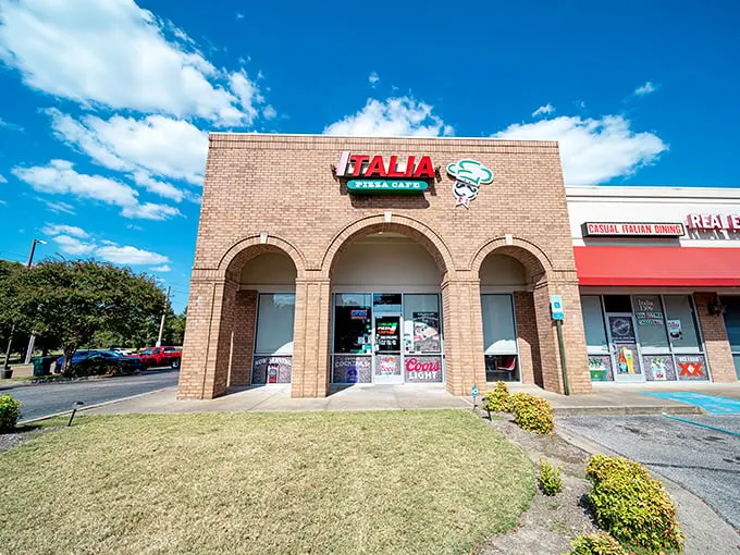 Welcome to pizza paradise! Italia Pizza Cafe's unassuming exterior hides a world of cheesy delights, proving you should never judge a book by its brick-and-mortar cover.