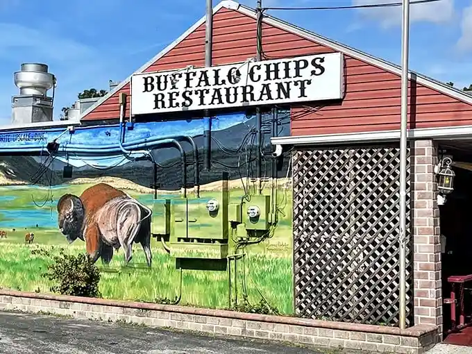 The unmistakable red exterior of Buffalo Chips, where that magnificent buffalo mural isn't just decoration—it's a promise of what awaits your taste buds inside.