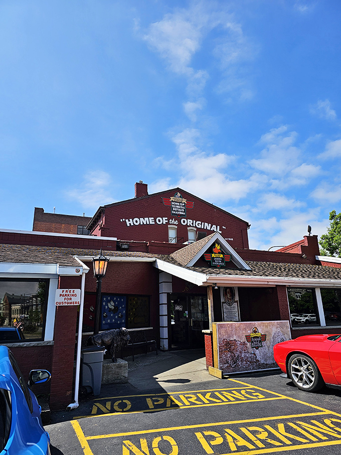 The unassuming red brick exterior of Anchor Bar proudly declares itself "Home of the Origin" – where culinary history was made one fateful night in 1964.