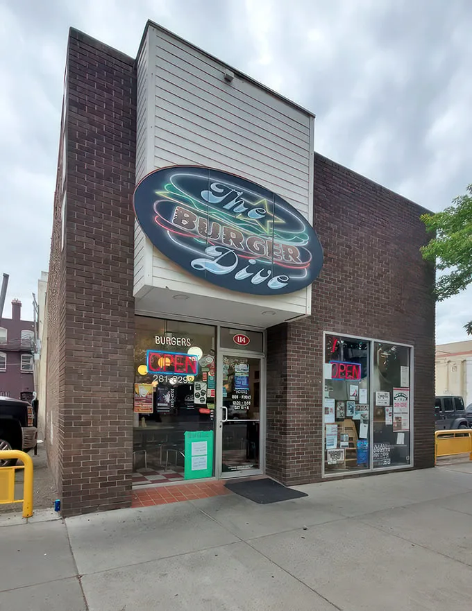 Step into burger paradise! The Burger Dive's retro neon sign beckons, while a majestic bison mural keeps watch. It's like a time-traveling foodie's dream come true.