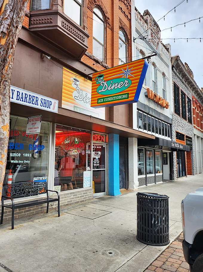 That iconic orange and teal sign doesn't just promise air conditioning—it's announcing your arrival at breakfast paradise on Main Street.