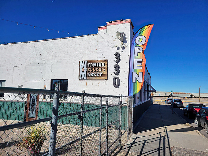 The unassuming white exterior with its vibrant "OPEN" flag is like a poker player hiding a royal flush—treasures await inside this Casper landmark.