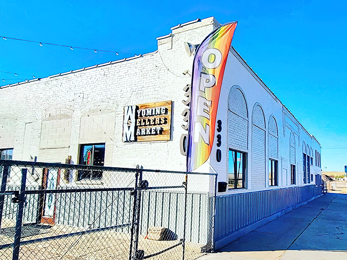 The unassuming white exterior with its vibrant "OPEN" flag is like a poker player hiding a royal flush—treasures await inside this Casper landmark.