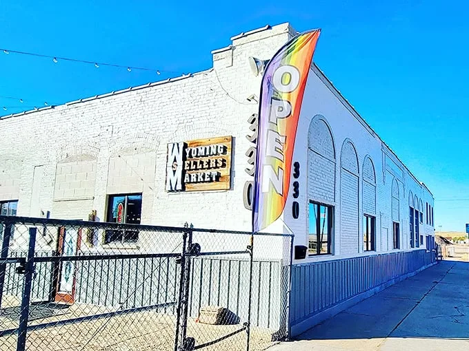 The unassuming white exterior with its vibrant "OPEN" flag is like a poker player hiding a royal flush—treasures await inside this Casper landmark.