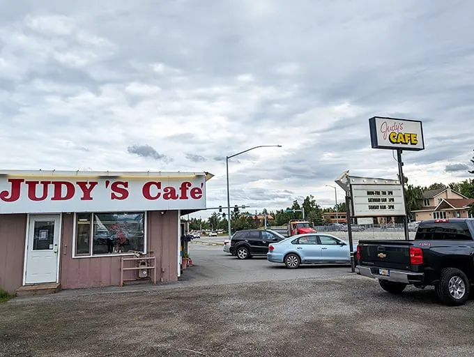 Welcome to Judy's Café, where the sign shines brighter than an Alaskan summer day! This unassuming exterior hides a treasure trove of comfort food delights.