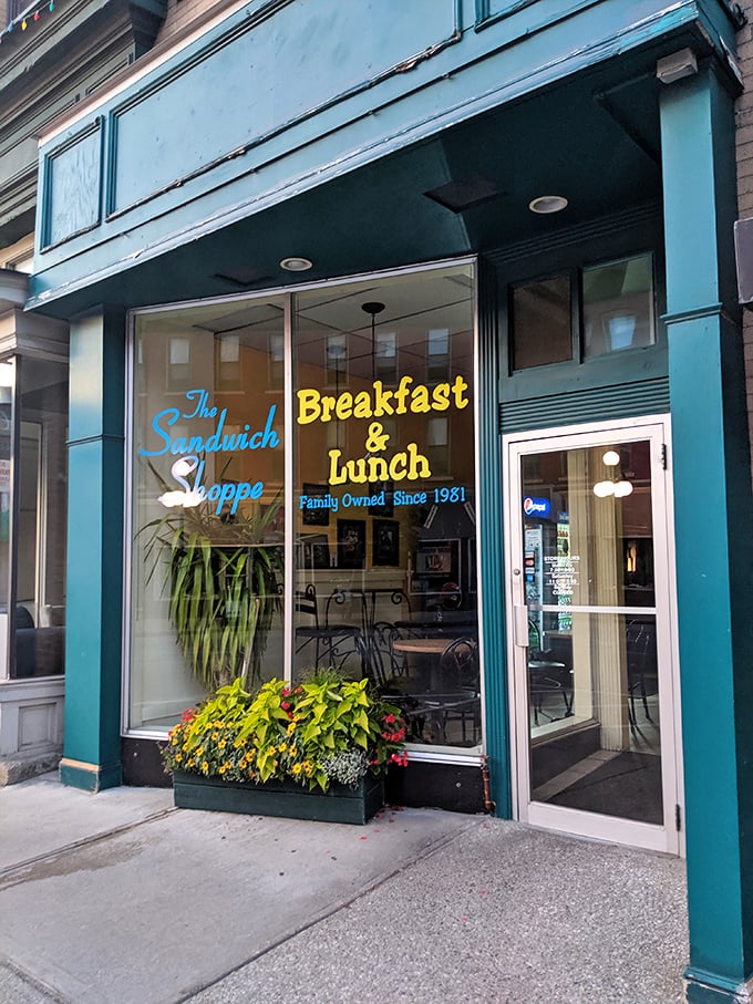 A teal oasis in a sea of brick and mortar! The Sandwich Shoppe's storefront promises a feast for both eyes and stomach.
