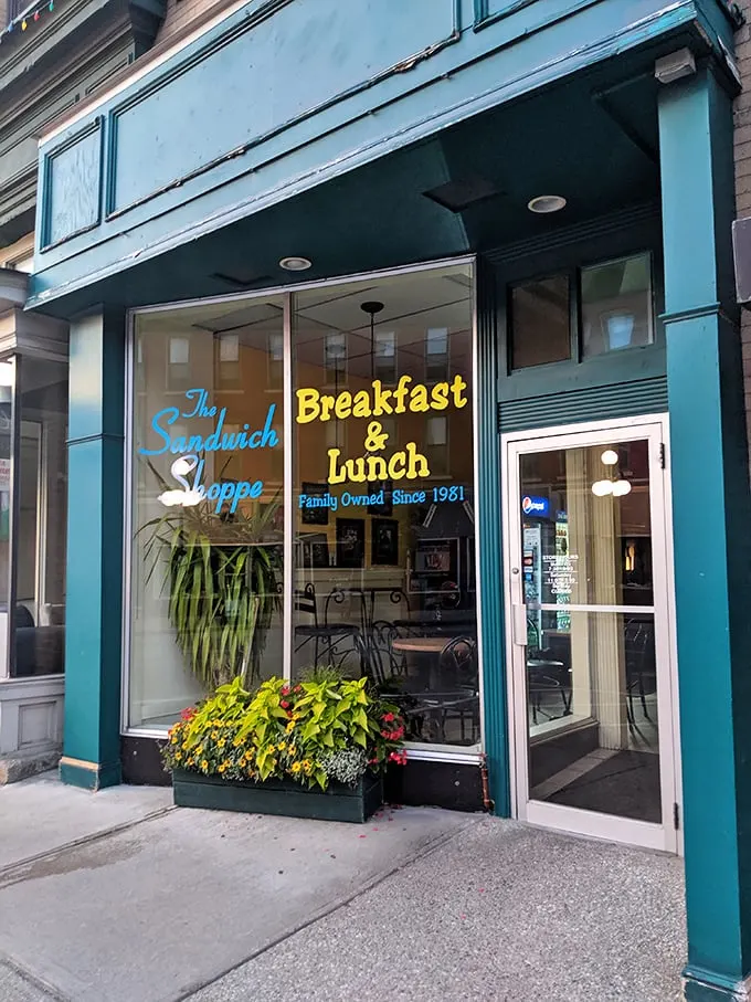 A teal oasis in a sea of brick and mortar! The Sandwich Shoppe's storefront promises a feast for both eyes and stomach.
