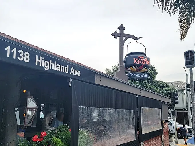 A stone's throw from paradise! The Kettle's charming exterior beckons with its rustic stonework and vibrant flower boxes, promising comfort food with a side of coastal charm.