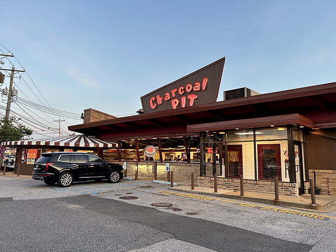 Welcome to the Charcoal Pit, where the 1950s never left and your diet goes on vacation! This retro wonderland serves up nostalgia with a side of neon-lit charm.