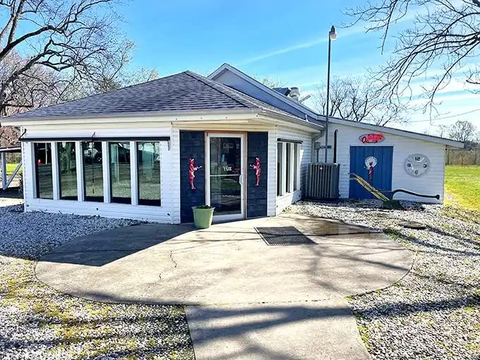 The unassuming white exterior with that iconic blue door is like a culinary TARDIS—modest on the outside, but containing breakfast universes within.