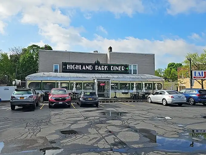 The gleaming stainless steel exterior of Highland Park Diner stands as a time capsule of Americana, beckoning hungry travelers with nostalgic charm.