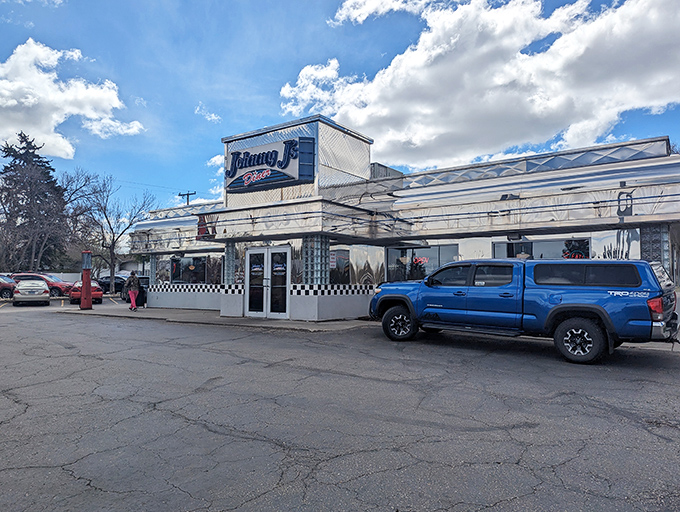 The classic blue-and-white facade of Johnny J's Diner stands as a beacon of comfort food in Casper, Wyoming—checkerboard trim signaling breakfast paradise within.
