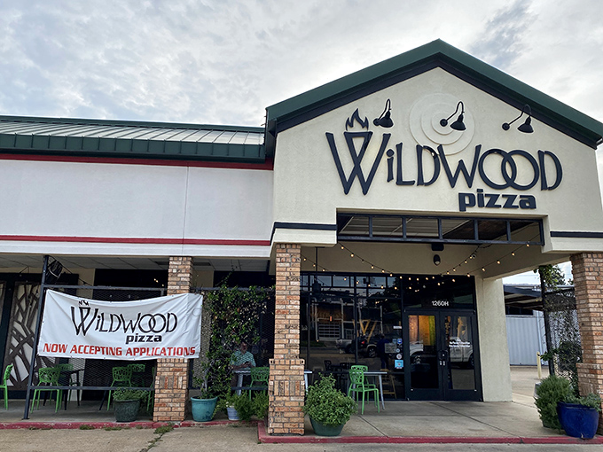 Welcome to Wildwood Pizza, where the exterior is as inviting as the aroma wafting through the door. It's like a pizza-scented beacon calling you home.