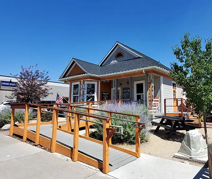 Home is where the smoke signals rise. Brothers Barbecue's charming cottage exterior with its bright orange accents promises comfort before you even step inside.