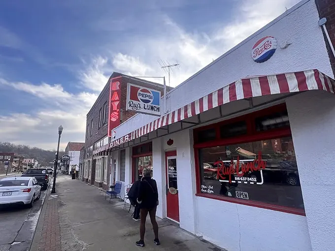 The classic white facade with red-striped awning isn't just inviting—it's practically a time machine to when breakfast cost less than your morning latte.