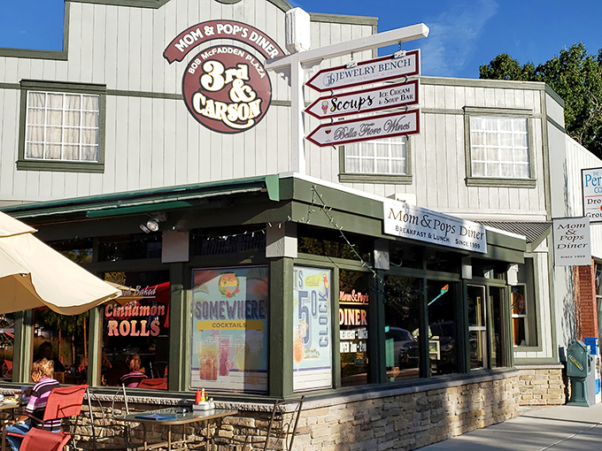 The cheerful exterior of Mom & Pop's Diner promises paradise in pancake form, with its inviting red umbrellas and laid-back Carson City charm.