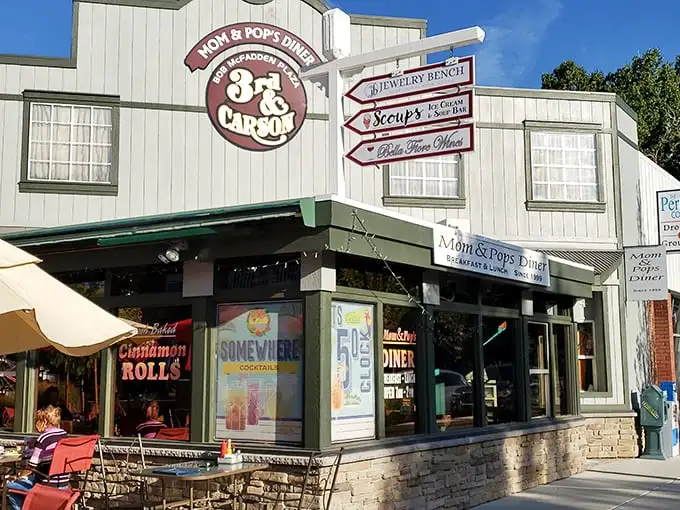 The cheerful exterior of Mom & Pop's Diner promises paradise in pancake form, with its inviting red umbrellas and laid-back Carson City charm.
