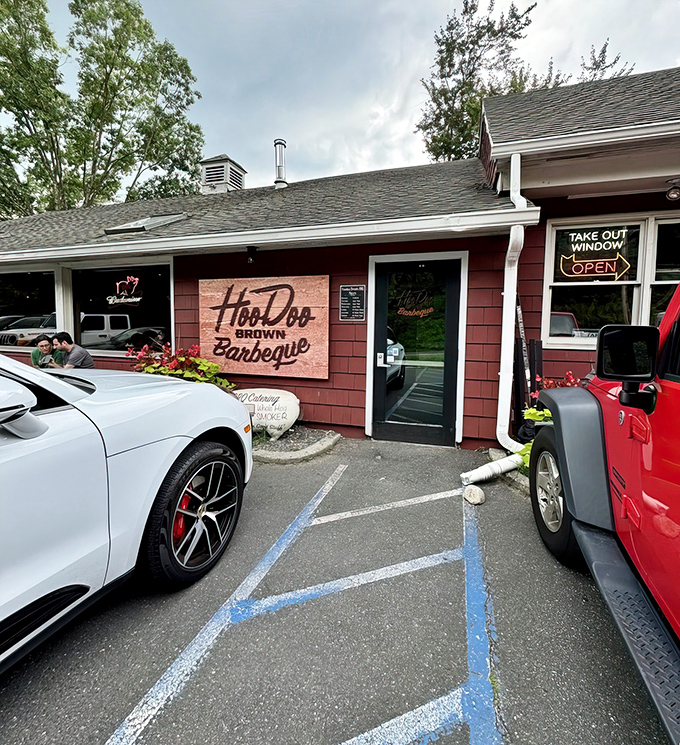 The unassuming red exterior of Hoodoo Brown BBQ proves once again that the best barbecue joints rarely dress to impress—they let the smoke do the talking.