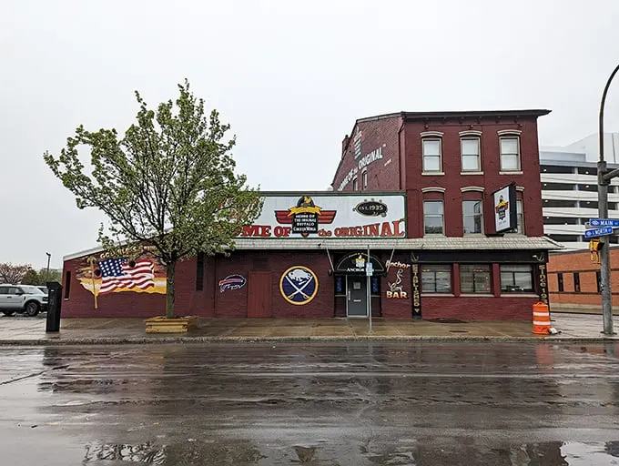 The unassuming red brick exterior of Anchor Bar proudly declares itself "Home of the Origin" – where culinary history was made one fateful night in 1964.