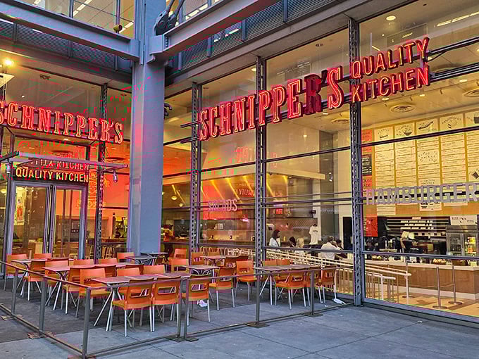 That iconic red Schnipper's sign beckons like a neon promise of comfort food nirvana. The orange chairs outside practically scream "sit here and be happy!"