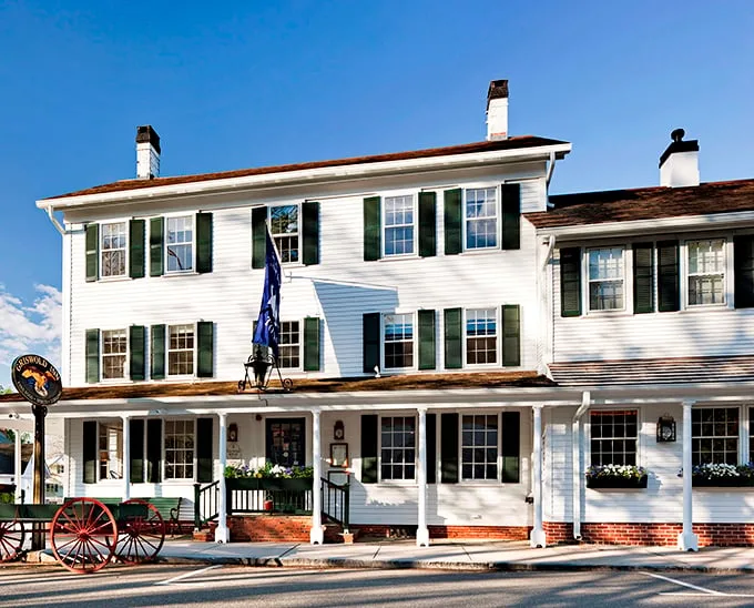 A slice of Americana served with a side of maritime charm. The Griswold Inn's white clapboard exterior whispers tales of centuries past, while the American flag proudly waves hello.