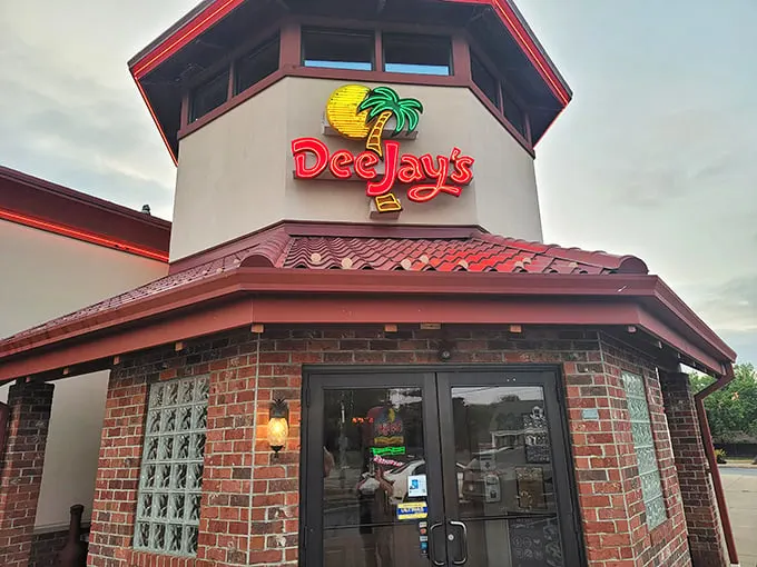 Welcome to flavor paradise! Dee Jay's exterior promises a tropical escape, complete with a palm tree logo that's more inviting than a hammock on a sunny day.