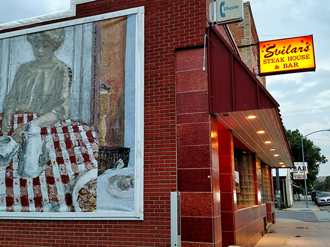 A red-brick beacon of culinary delight! Svilar's Steak House & Bar stands proud, its neon sign a siren call to hungry travelers and locals alike.