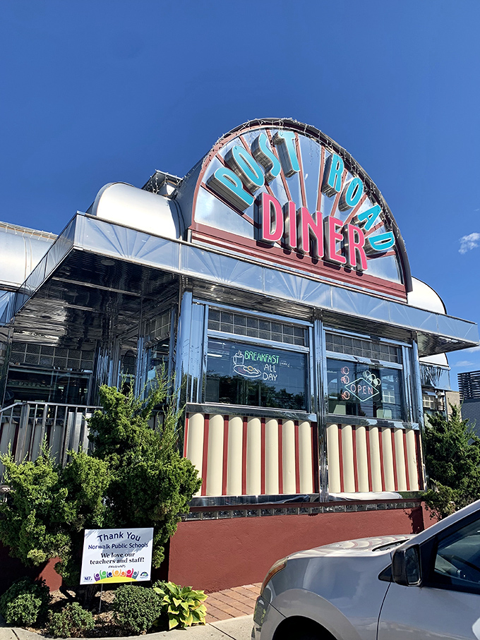 Retro chic meets modern appetite! The Post Road Diner's neon sign beckons like a lighthouse for the hungry, promising a voyage through time and taste.