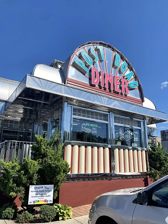 Retro chic meets modern appetite! The Post Road Diner's neon sign beckons like a lighthouse for the hungry, promising a voyage through time and taste.
