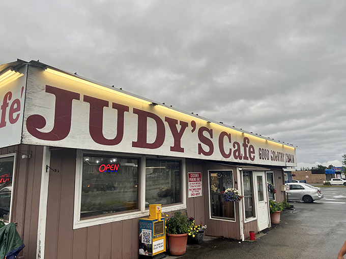 Welcome to Judy's Café, where the sign shines brighter than an Alaskan summer day! This unassuming exterior hides a treasure trove of comfort food delights.