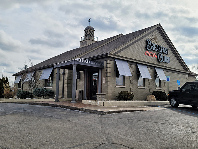 Welcome to breakfast paradise! The Breakfast Clubb's charming exterior promises a feast for the senses, with its inviting awnings and cozy brick facade.