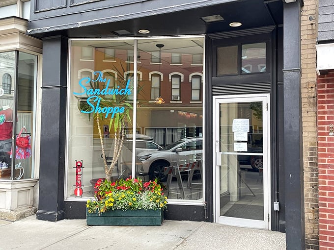 A teal oasis in a sea of brick and mortar! The Sandwich Shoppe's storefront promises a feast for both eyes and stomach.