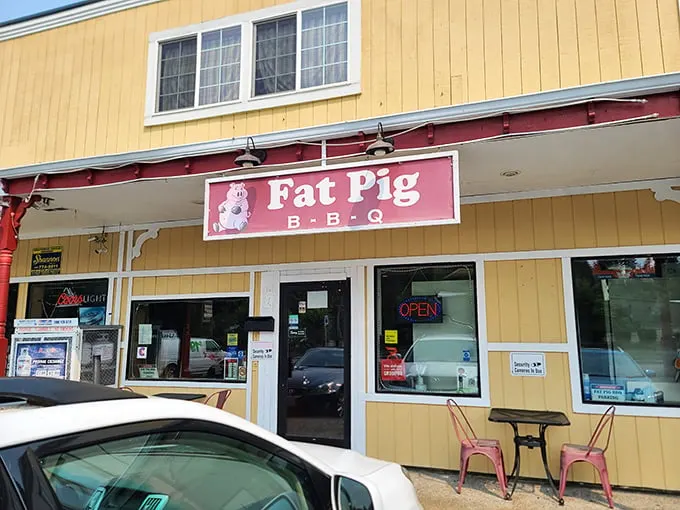 Welcome to BBQ paradise! Fat Pig BBQ's cheerful yellow exterior and pink sign promise smoky delights that'll make your taste buds do a happy dance.