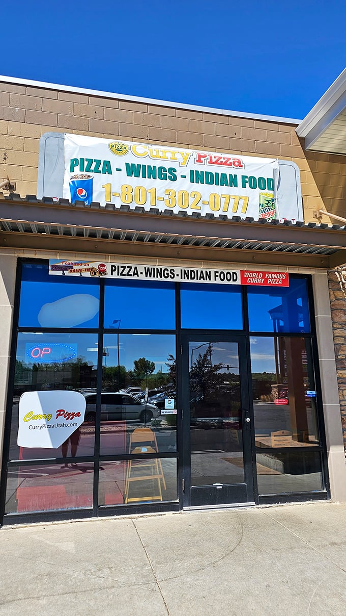 Welcome to flavor paradise! This unassuming storefront houses a culinary adventure where pizza meets curry in a delicious East-West fusion.