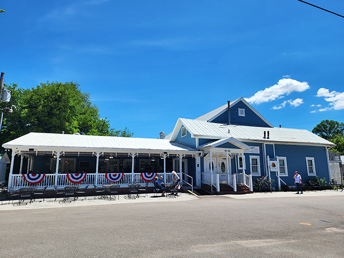 The storybook blue exterior with white trim beckons like a mirage in the Missouri countryside. No filter needed—this is pure small-town charm at its finest.