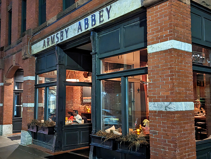 The historic brick façade of Armsby Abbey stands as Worcester's culinary beacon, its green trim and weathered sign promising gastronomic treasures within.